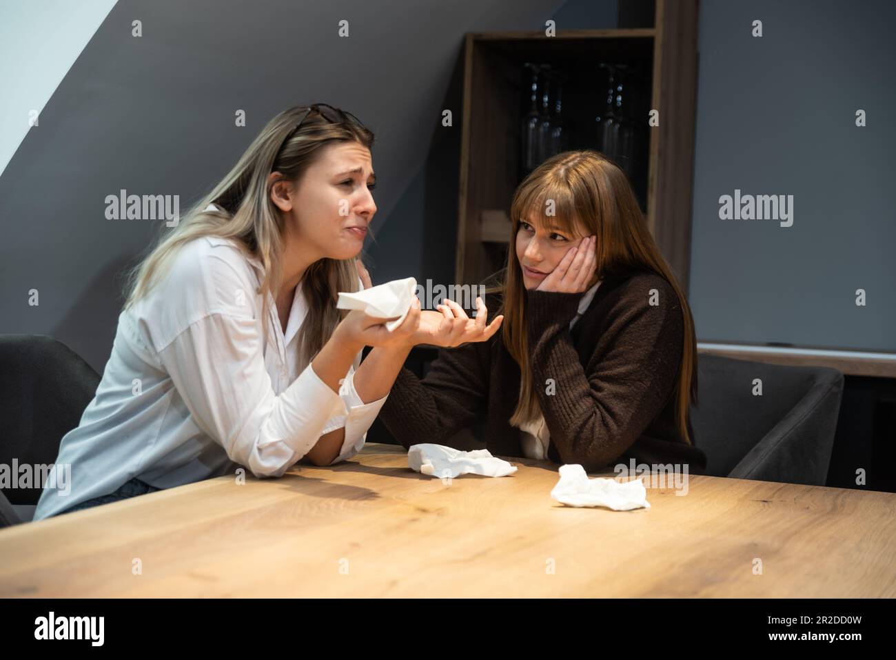 Young friend woman comforting her sad depressed colleague in office who ...
