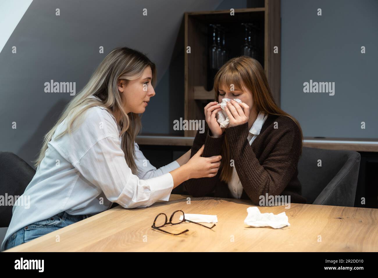 Young friend woman comforting her sad depressed colleague in office who ...