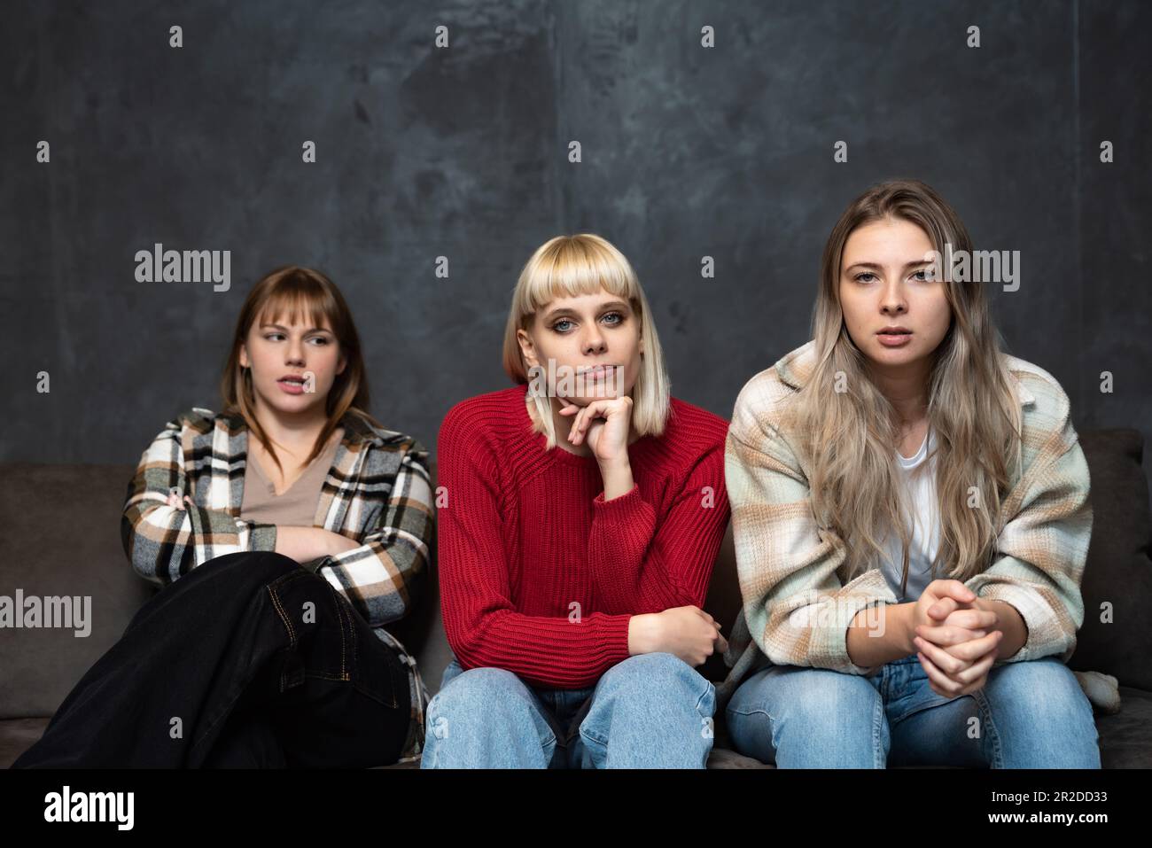 Three young candidates are waiting in the waiting room for a job ...