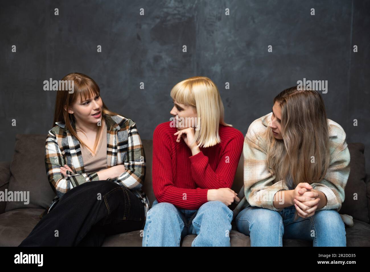 Three young candidates are waiting in the waiting room for a job ...