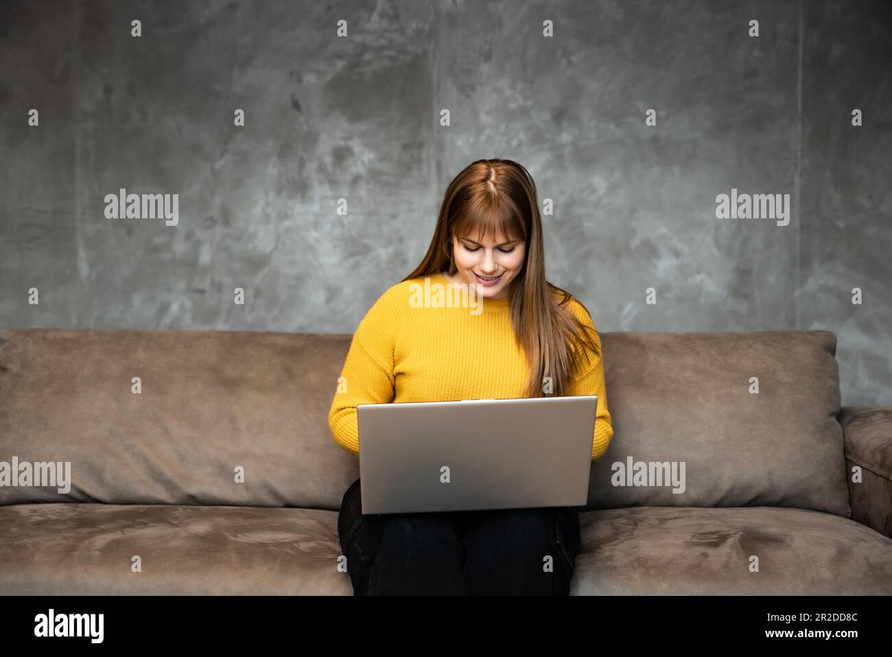 Young woman search the internet on laptop computer ads for selling and ...