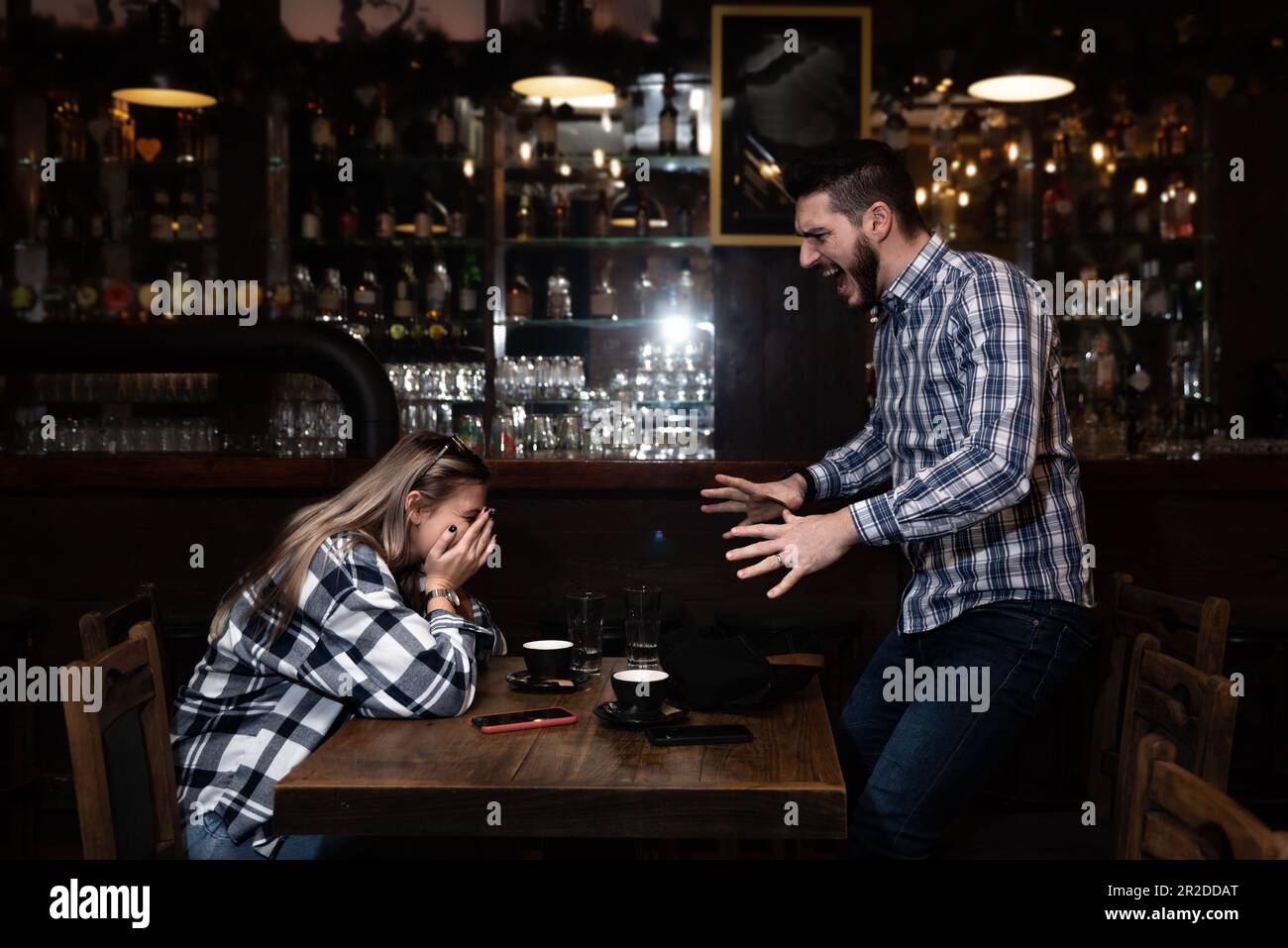 Young waiter resigns and leaves his job in a bar because of an argument ...