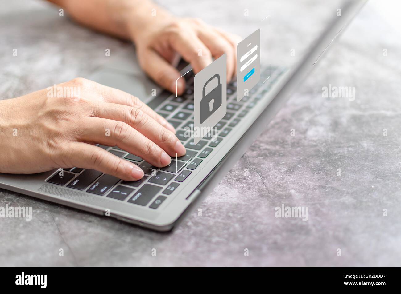 Man typing on keyboard to use computer network. Laptop screen showing login for security system ...