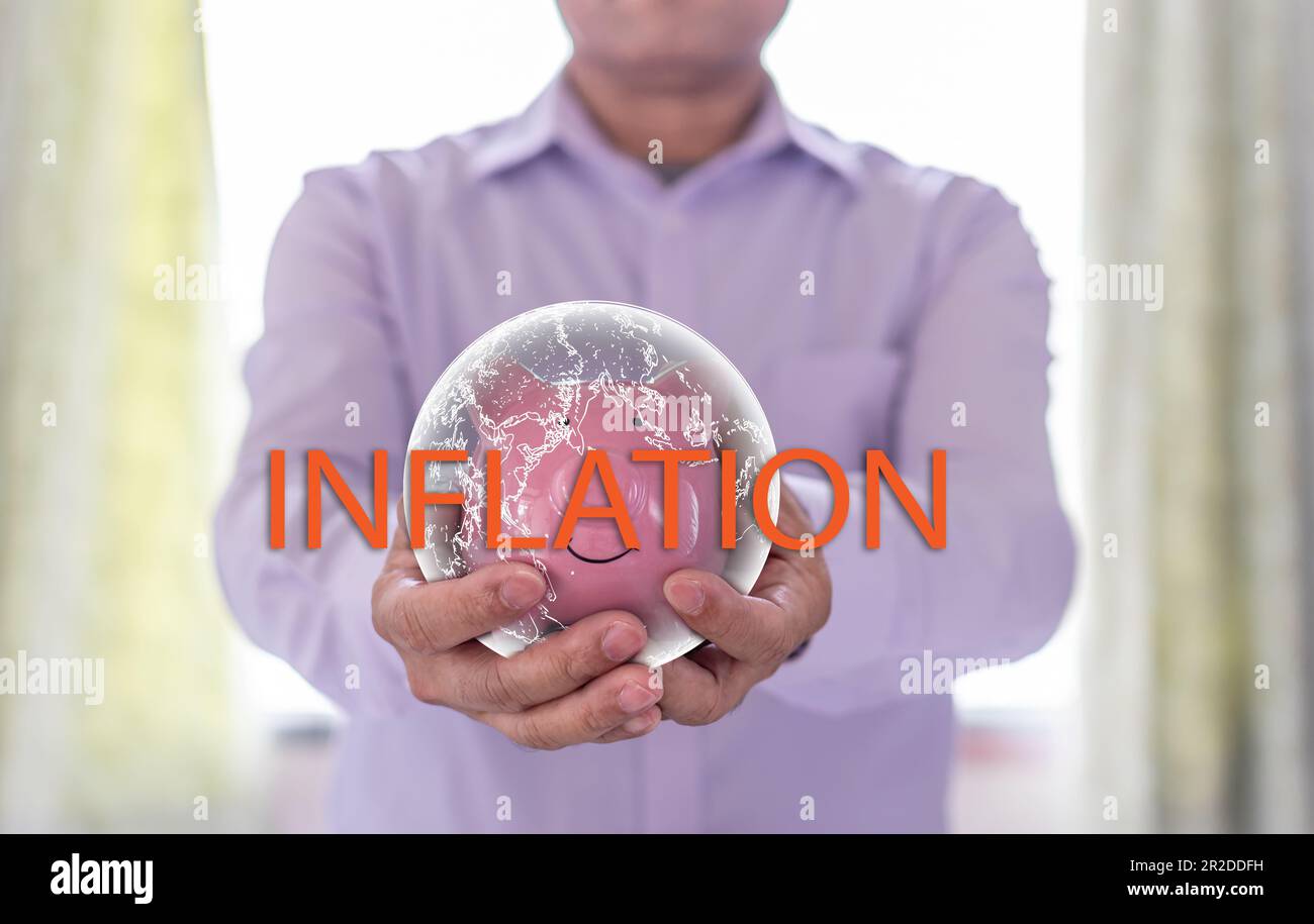 A Businessman holding a pink piggy bank in severe inflation situations ...