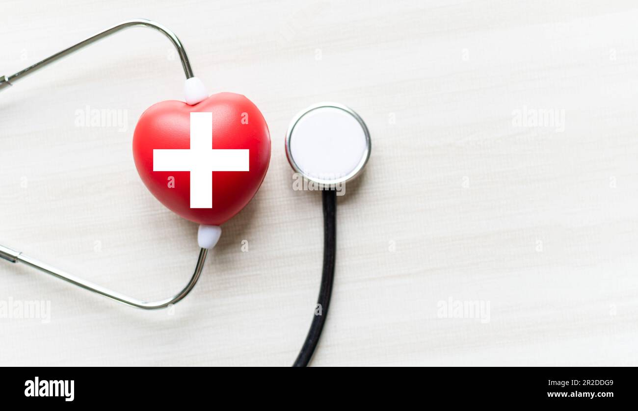 A red cross is a symbol of medical health. With a stethoscope and heart ...