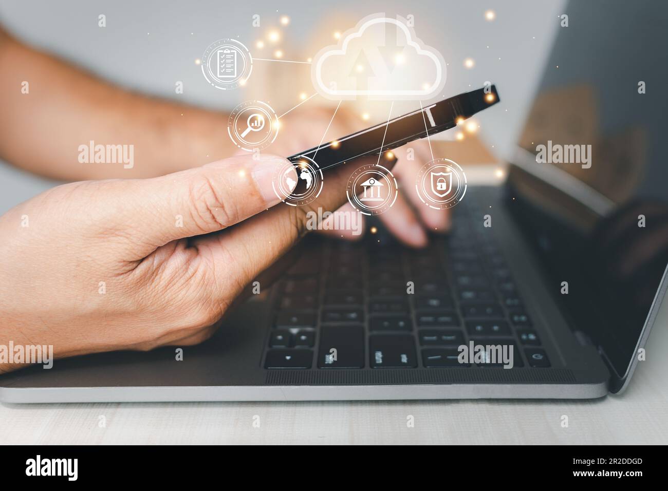Admin man uses a smartphone and laptop with a cloud computing diagram display on a virtual ...