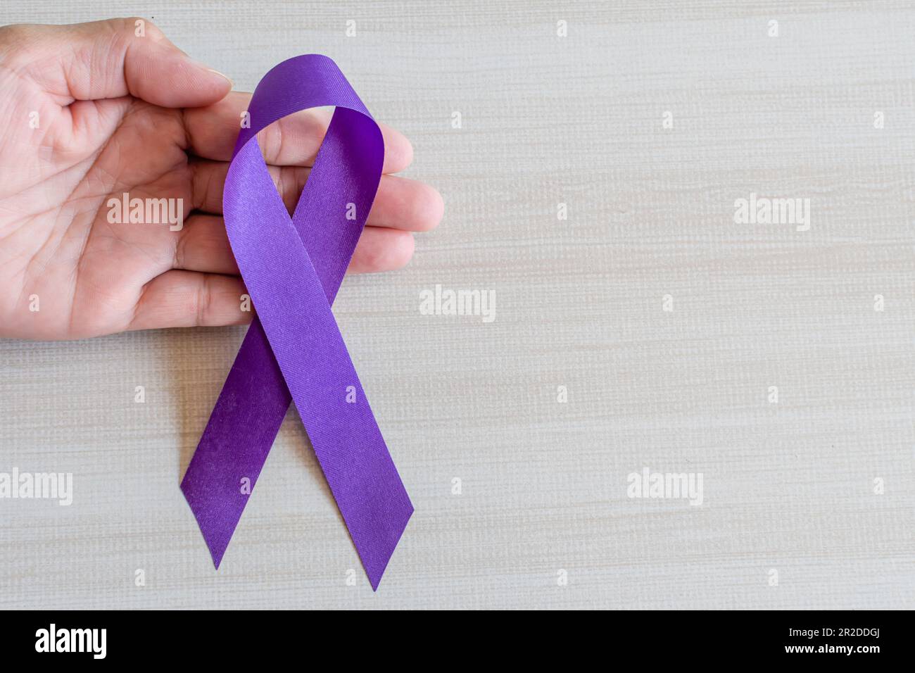 International Overdose Awareness Day, hand holds purple awareness ...