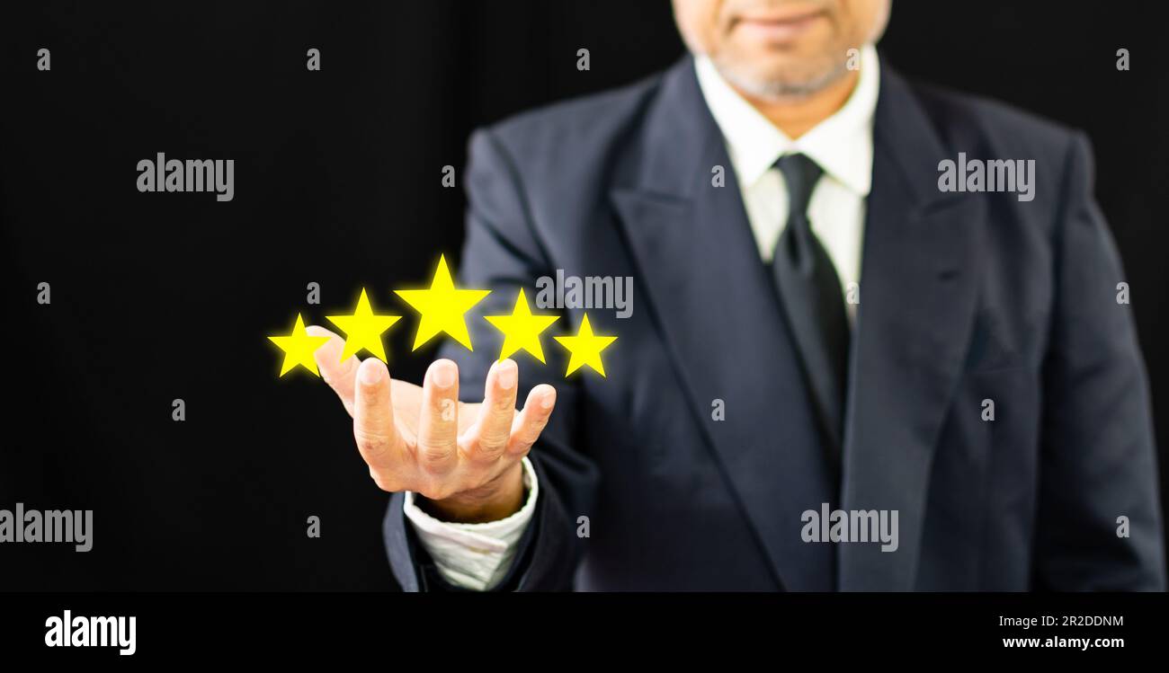 hand of businessman or customer holding stars to complete five stars ...