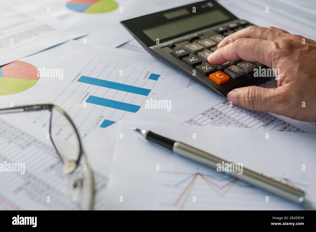 A businessman is calculating numbers with a calculator. concept ...