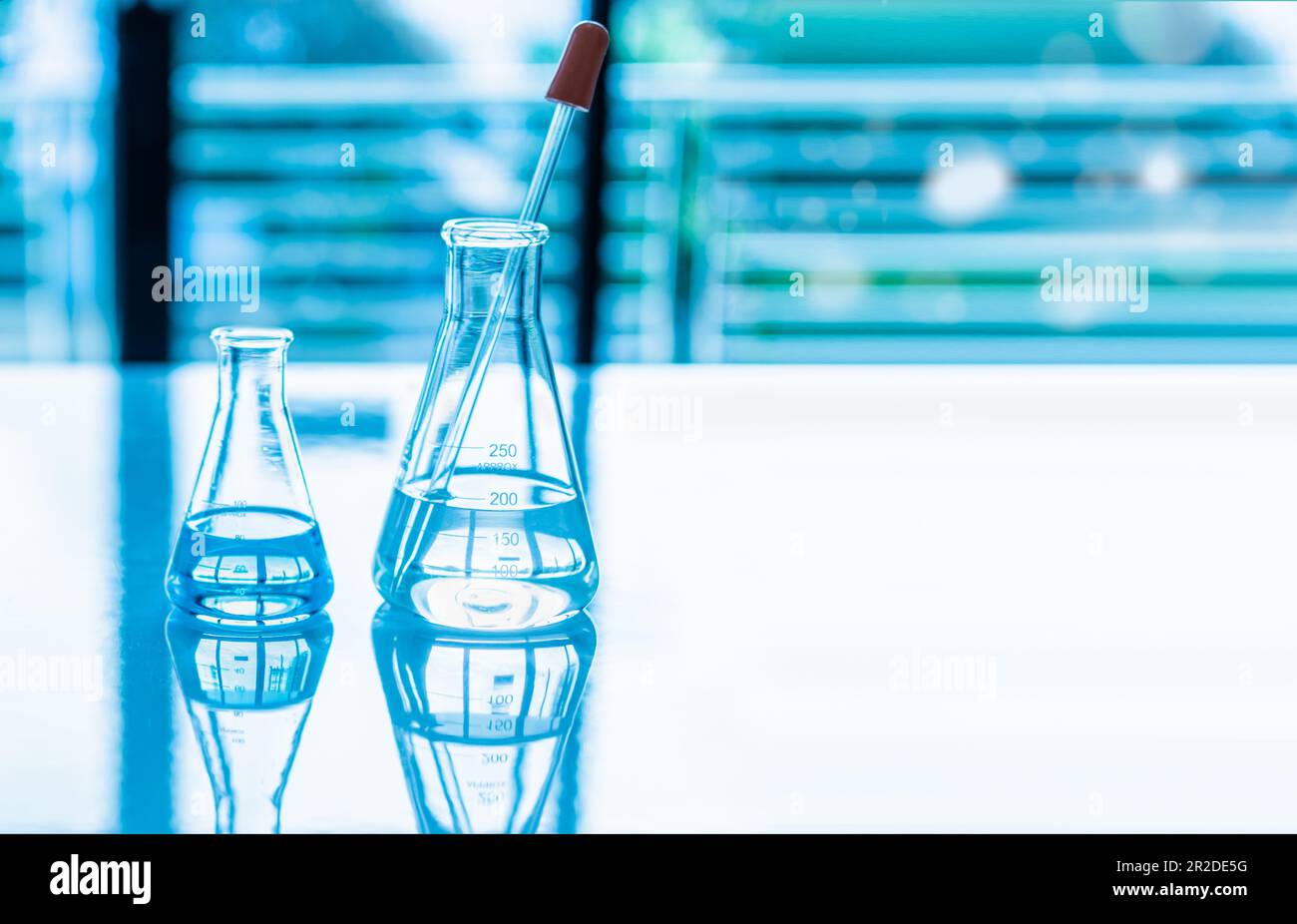 Chemistry experiment concept in science laboratory Two science flasks ...