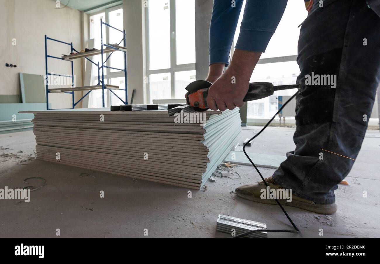 Drywall Installers. Men holding a gypsum board figured cut Stock Photo ...