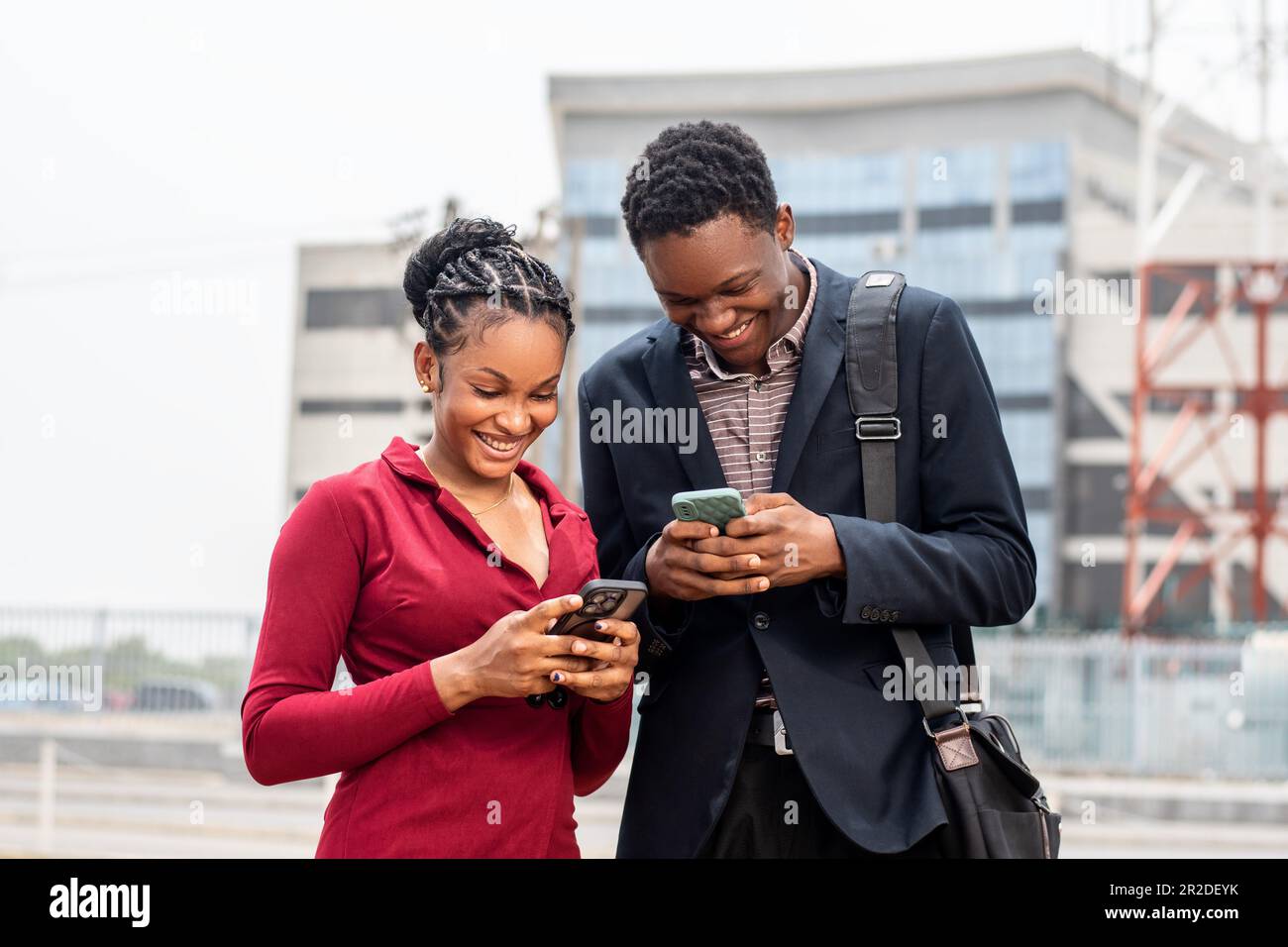 young african business people checking their phone outdoor Stock Photo ...