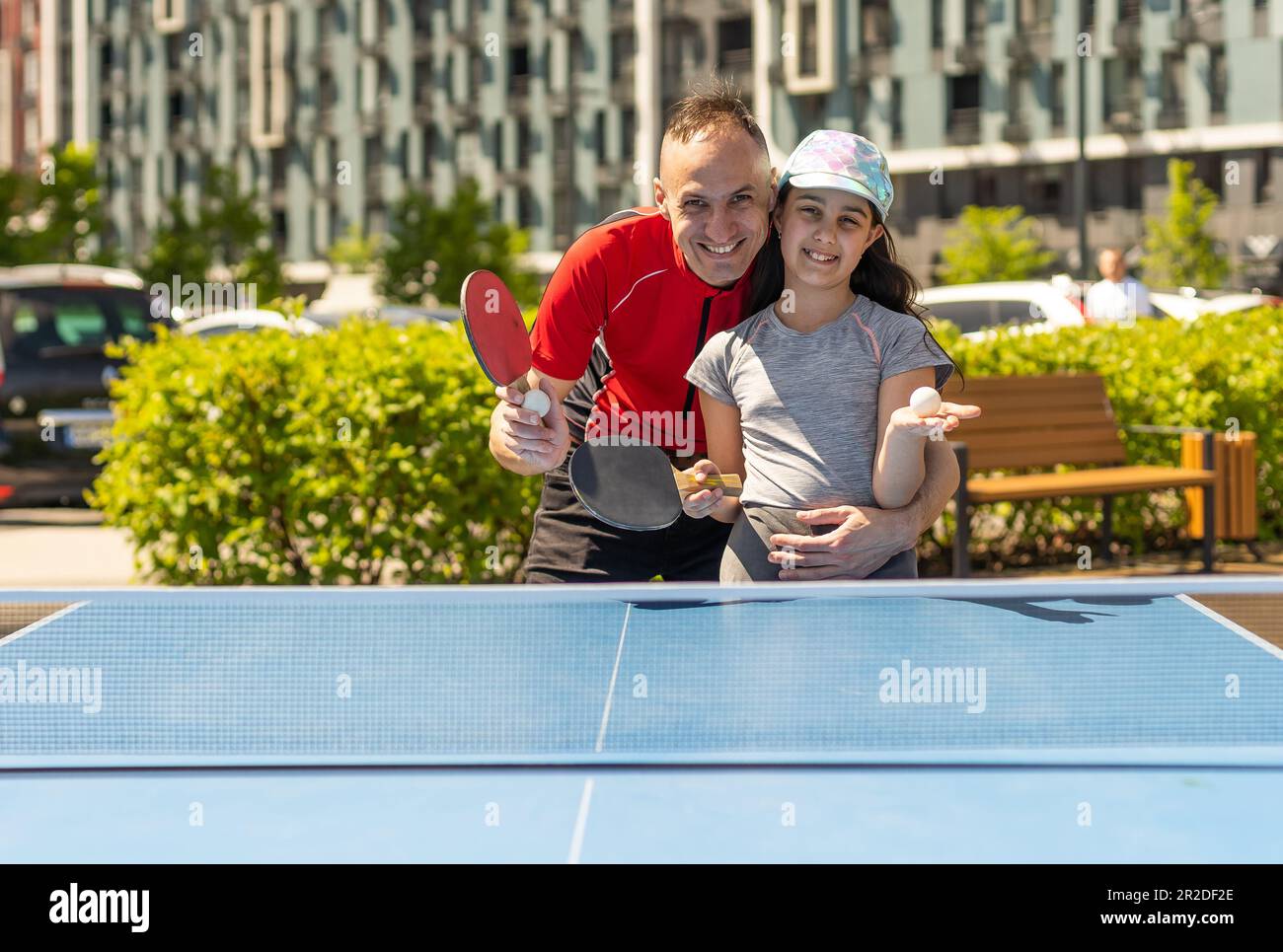 Family playing table tennis outside house Stock Photo - Alamy