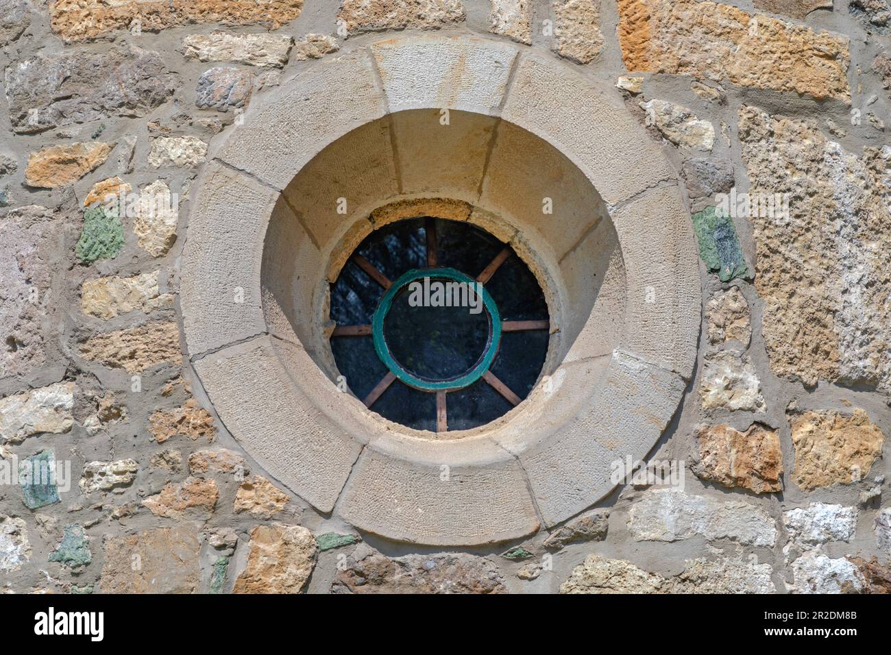 Small Round Window at Stone Wall Church Exterior Stock Photo - Alamy