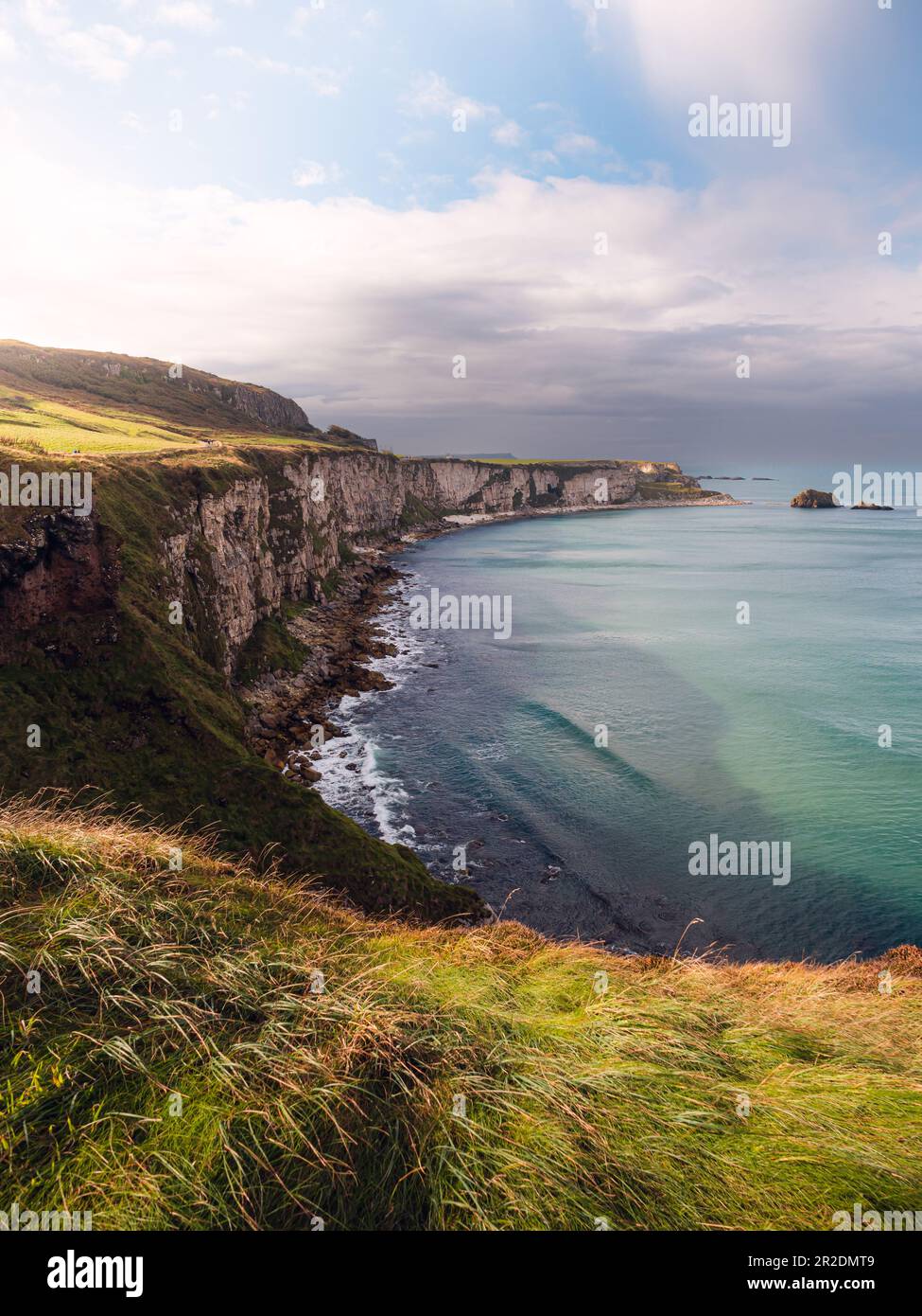 Coastal cliffs and grasses on the edge of the Atlantic Ocean. This is ...