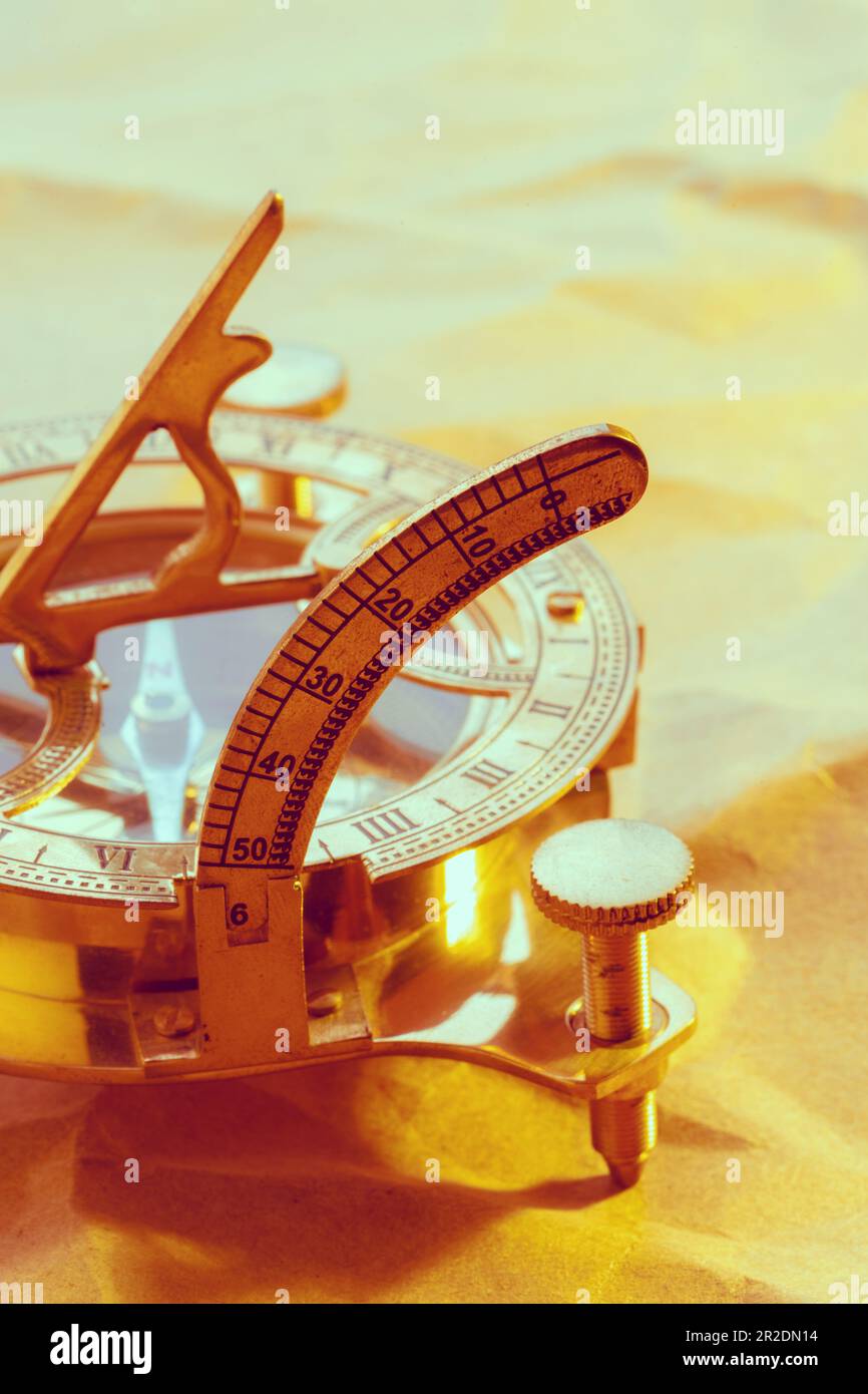 antique compass on vintage paper background Stock Photo - Alamy