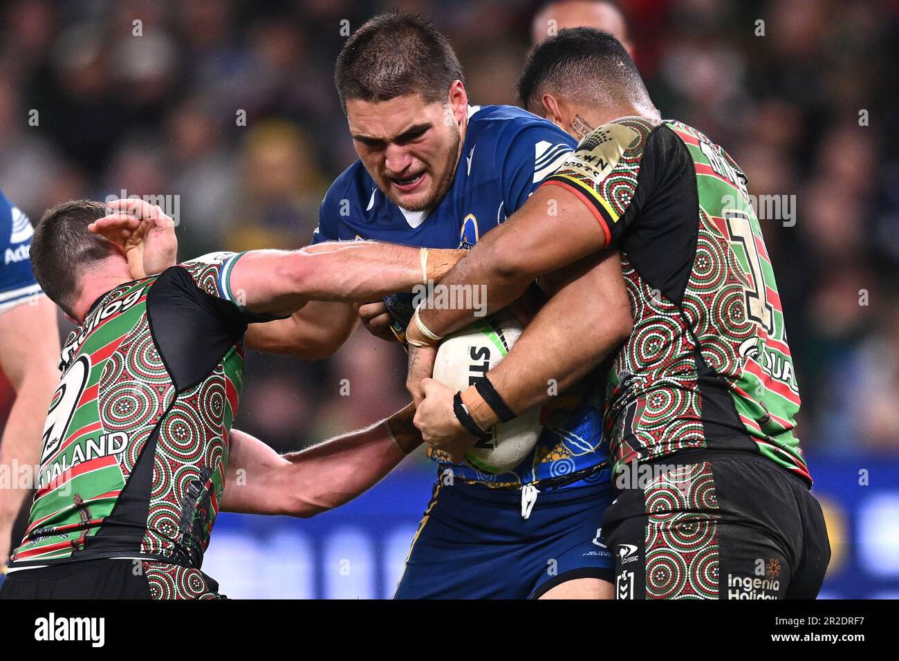 Wiremu Greig of the Eels is tackled by Damien Cook (left) and Daniel ...