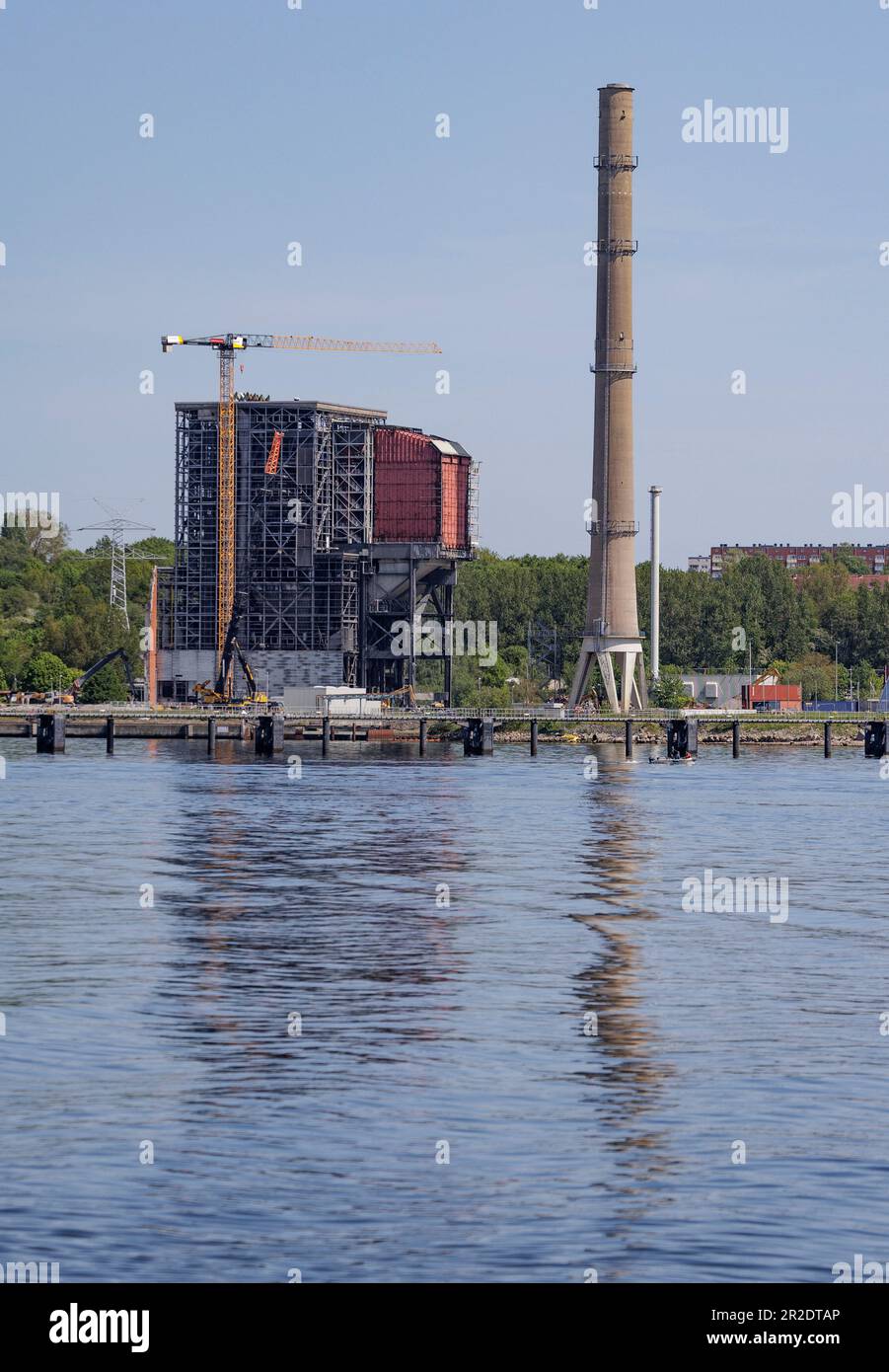 Kiel, Germany. 18th May, 2023. The sun falls on the smokestack and the ...