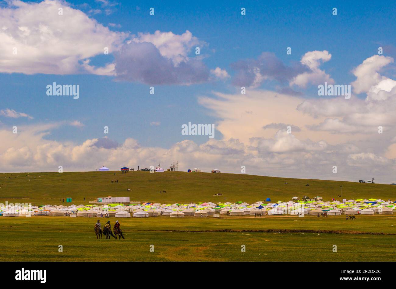 Nomadic village with 3 horsemen riding to the horse racing competition ...