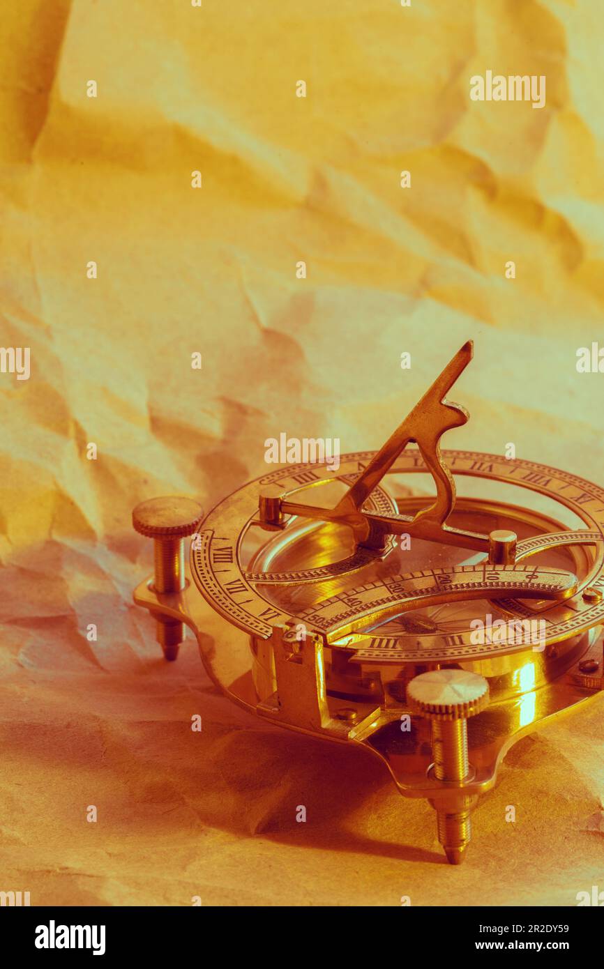 antique compass on vintage paper background Stock Photo - Alamy