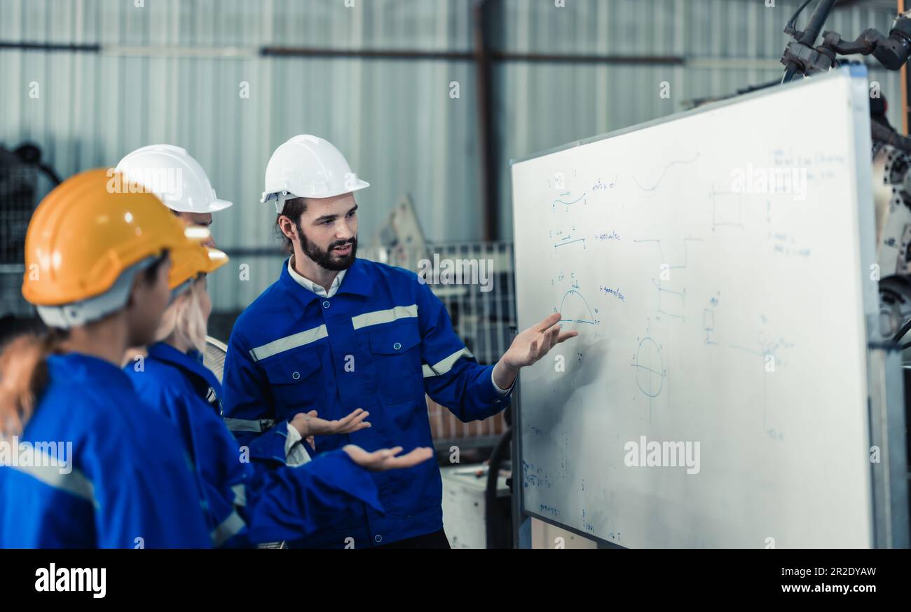 A group of robotic engineers collaboratively brainstorms and discusses ...