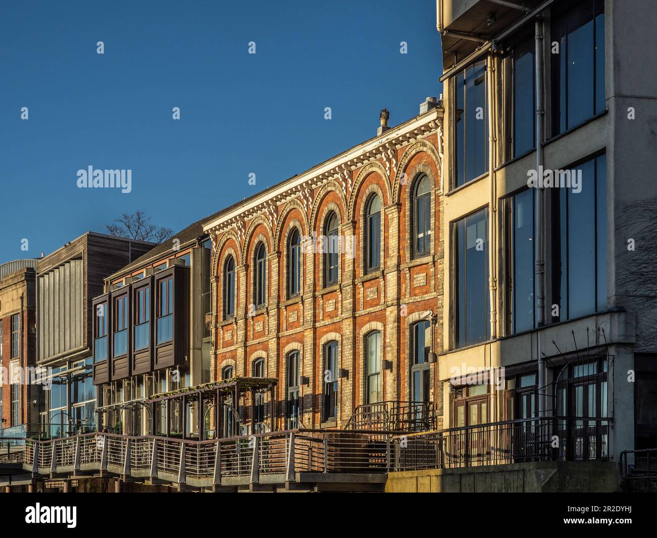 Red brick facade of Ebor Hall, with modern side extension and terrace ...