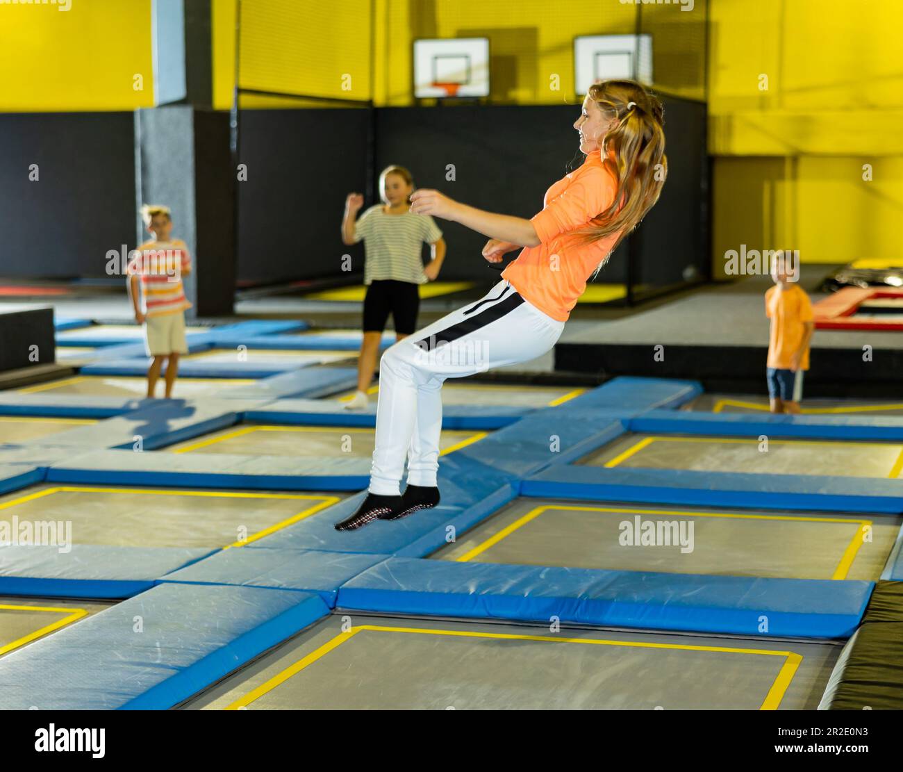 Teenage girl having fun jumping in indoor trampoline arena Stock Photo ...