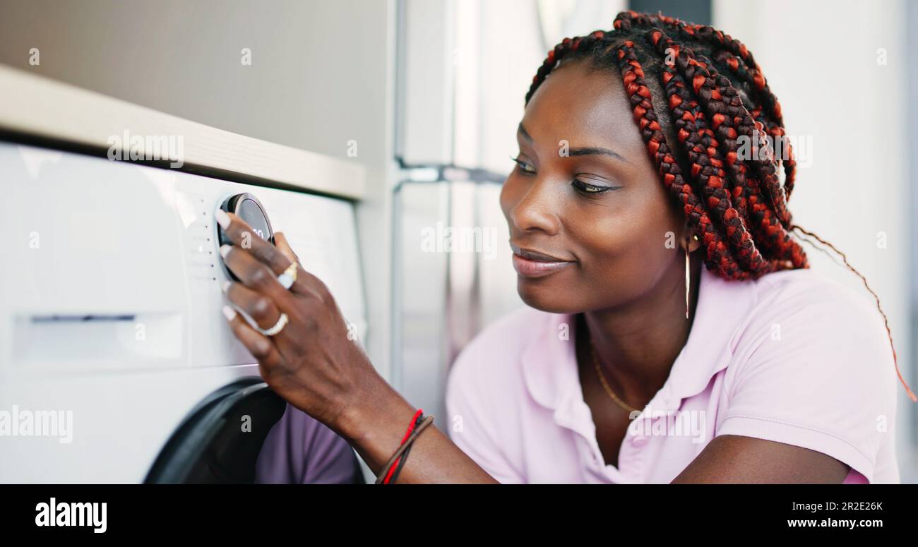 African woman washing machine button hi-res stock photography and ...