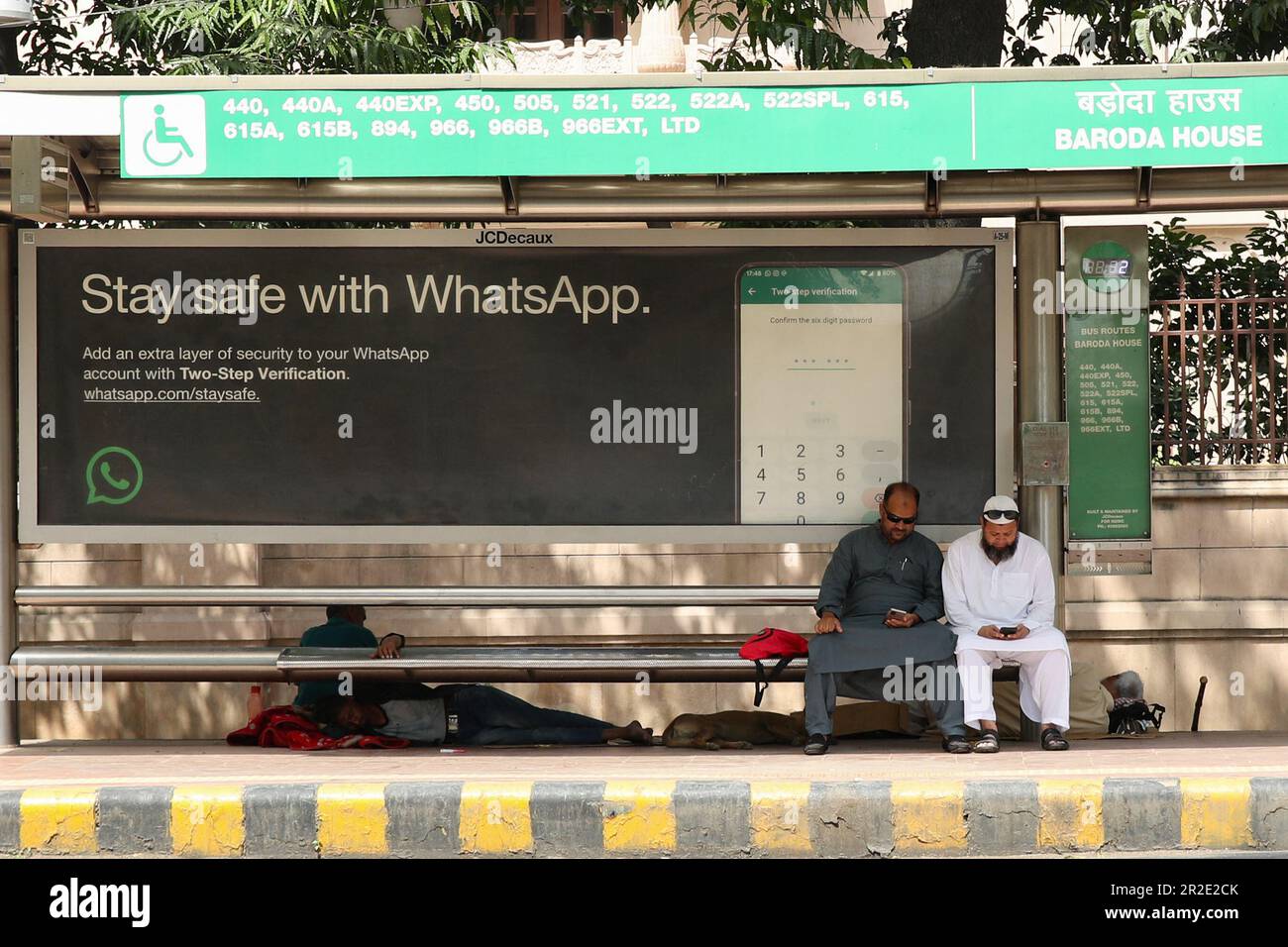 New Delhi, India. 19th May, 2023. People use mobile phones at a bus ...