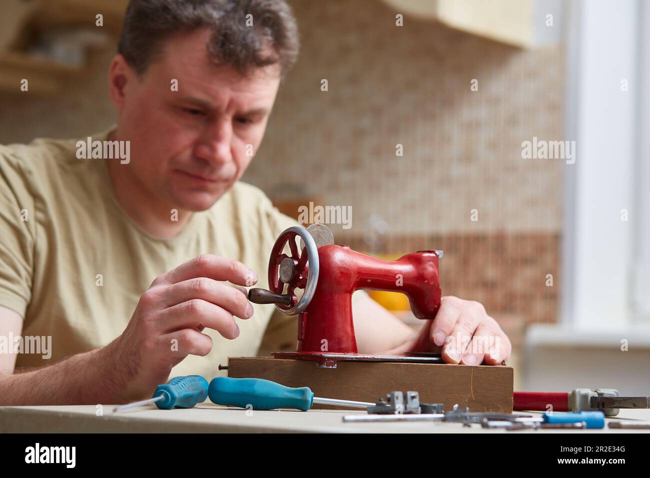 Professional adjustment of a sewing machine. Focus on the sewing ...