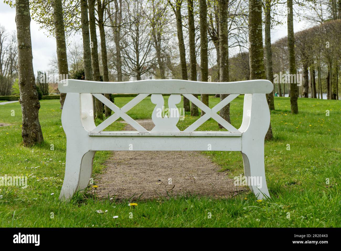 White bench in the baroque park of the Glücksburg moated castle ...