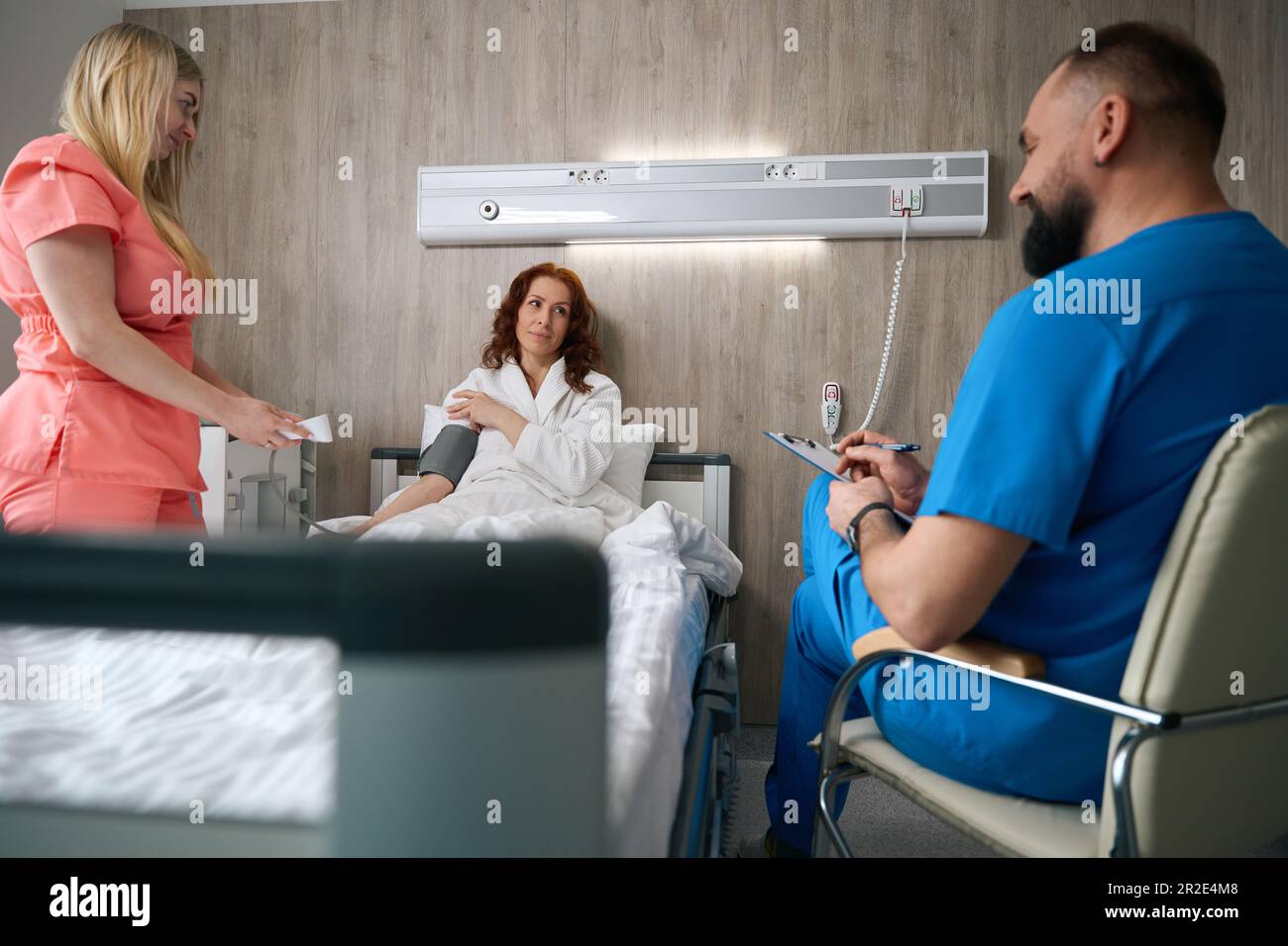 Caring doctor providing healthcare to woman patient in hospital Stock ...