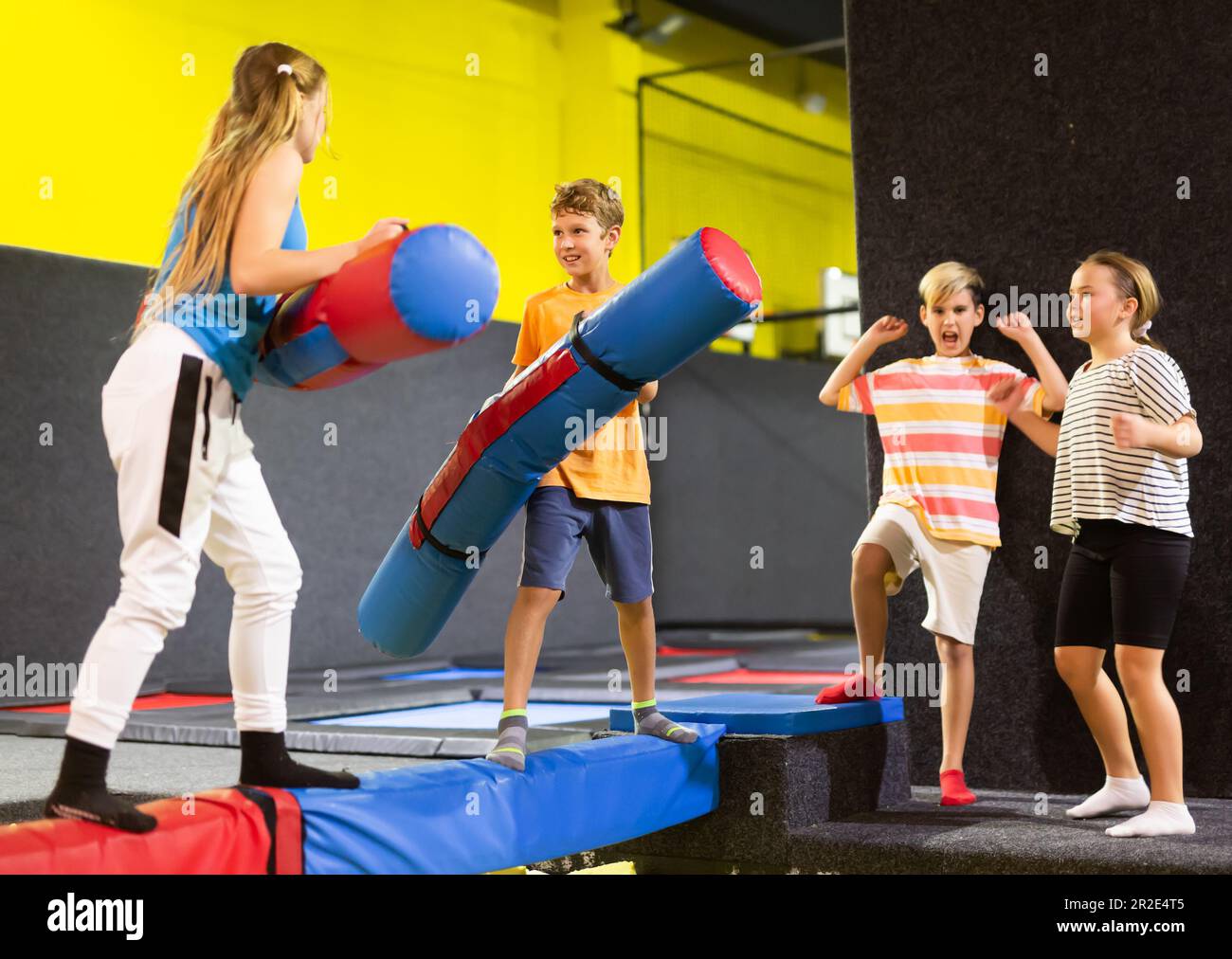 Preteen boy fighting by inflatable pugil sticks with girl Stock Photo ...