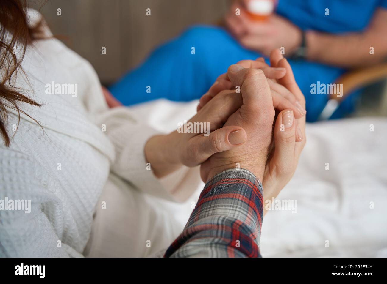 Couple giving helping hand to each other indoors Stock Photo - Alamy