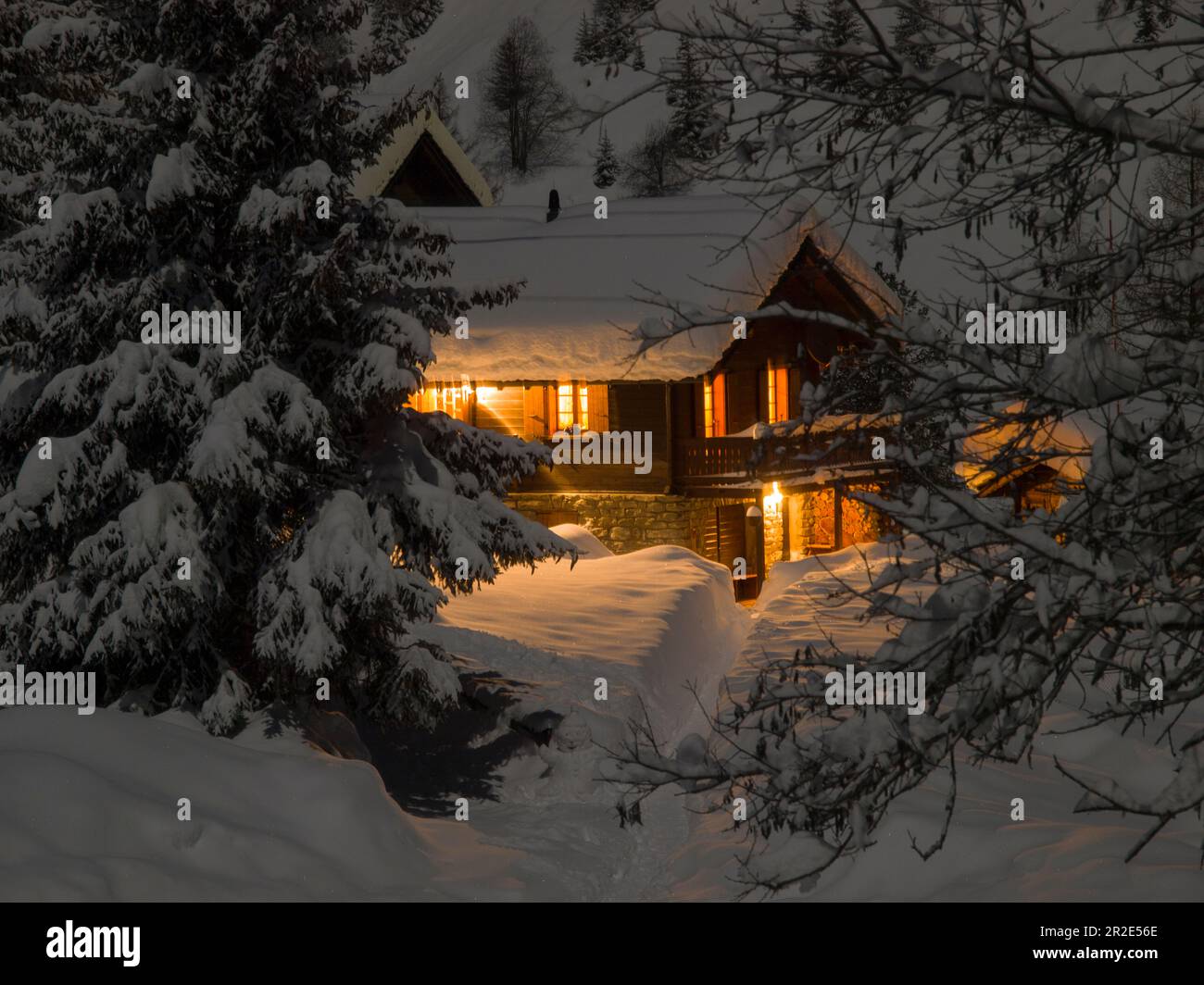 A winters night with a full moon in a small alpine village in ...
