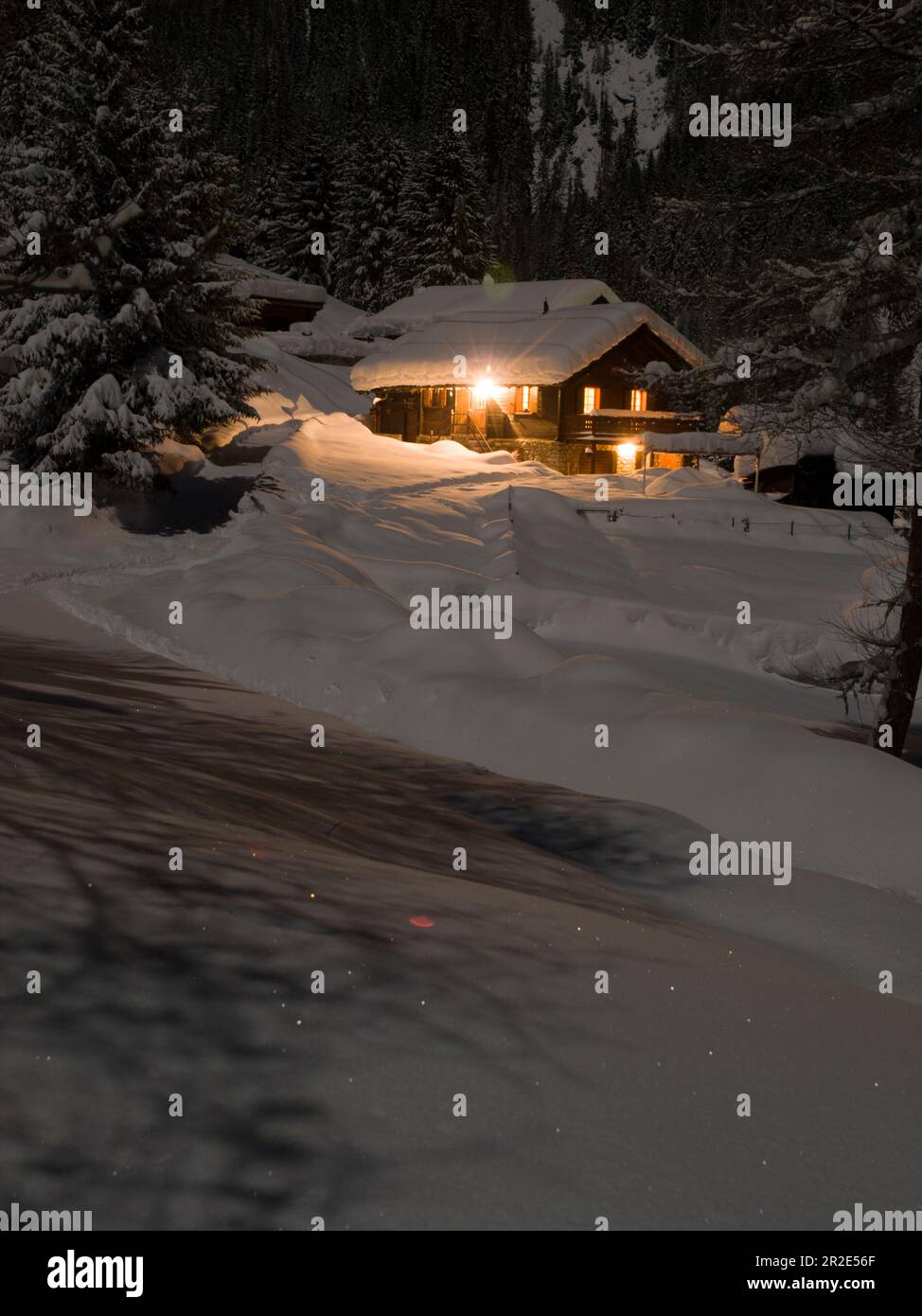 A winters night with a full moon in a small alpine village in ...