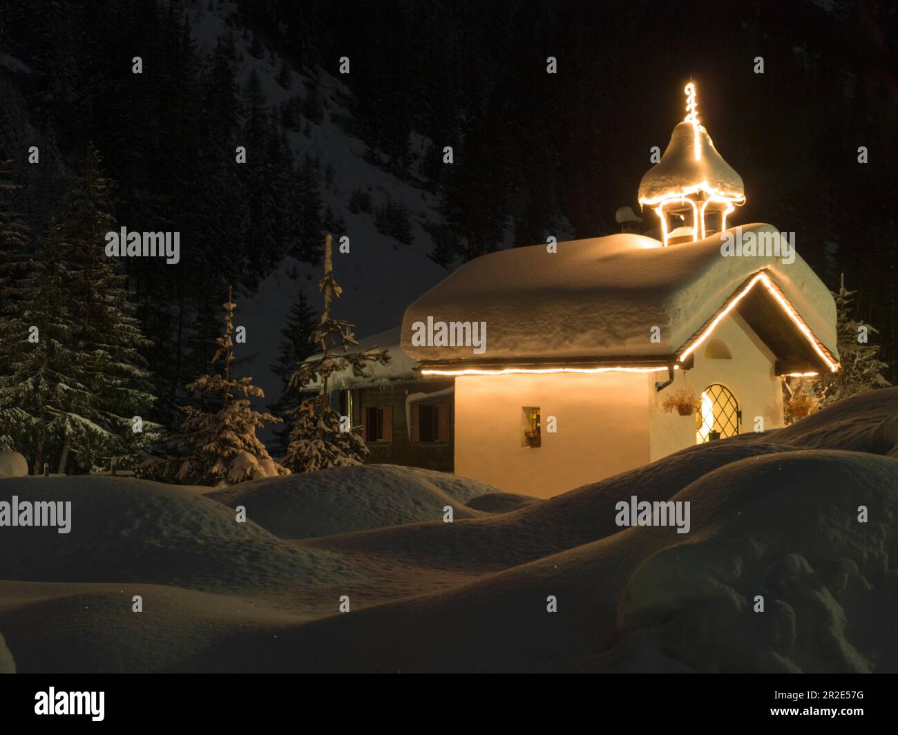 A winters night with a full moon in a small alpine village in ...