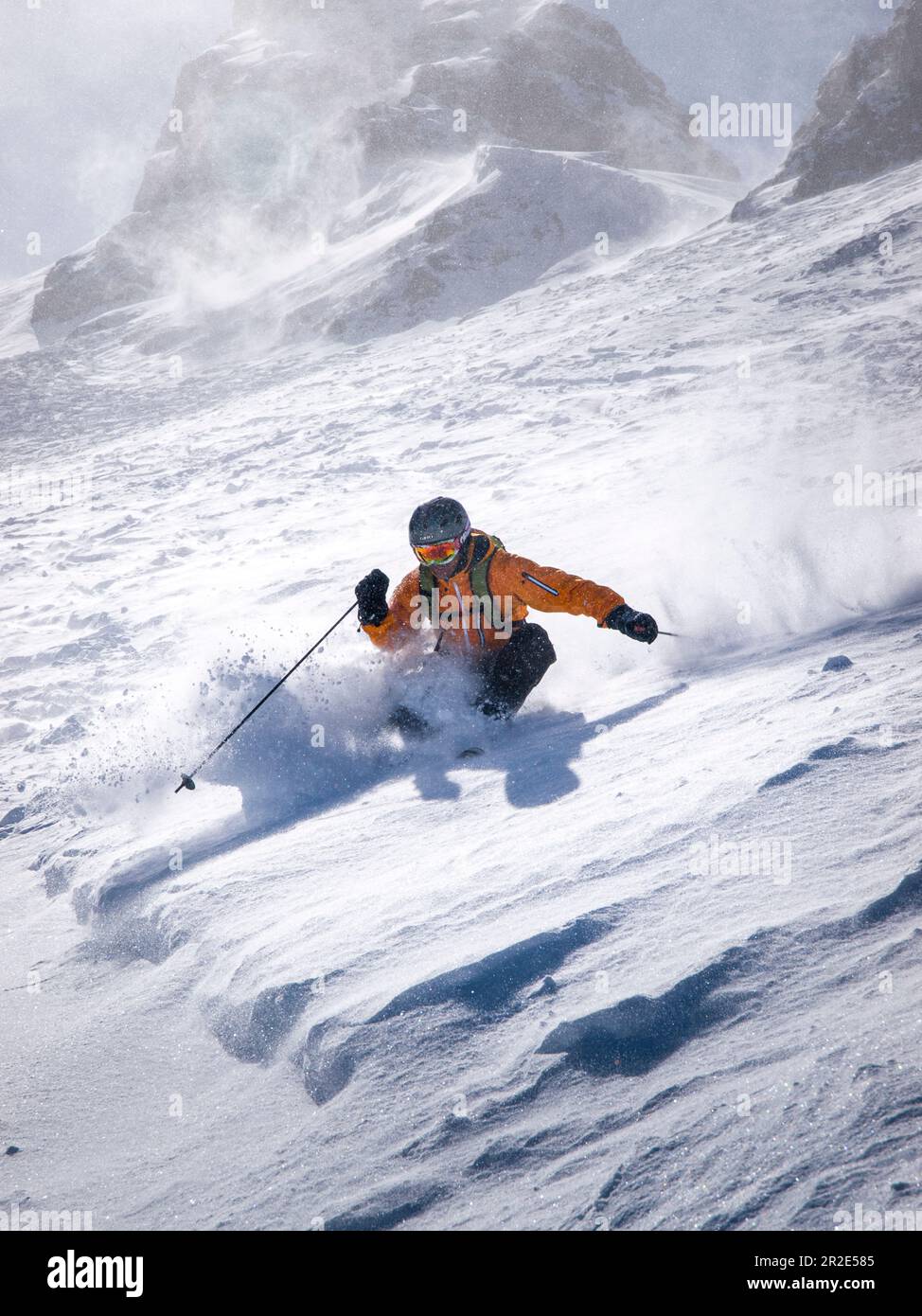Off piste male skier on a windy day in the mountains above Engelberg ...