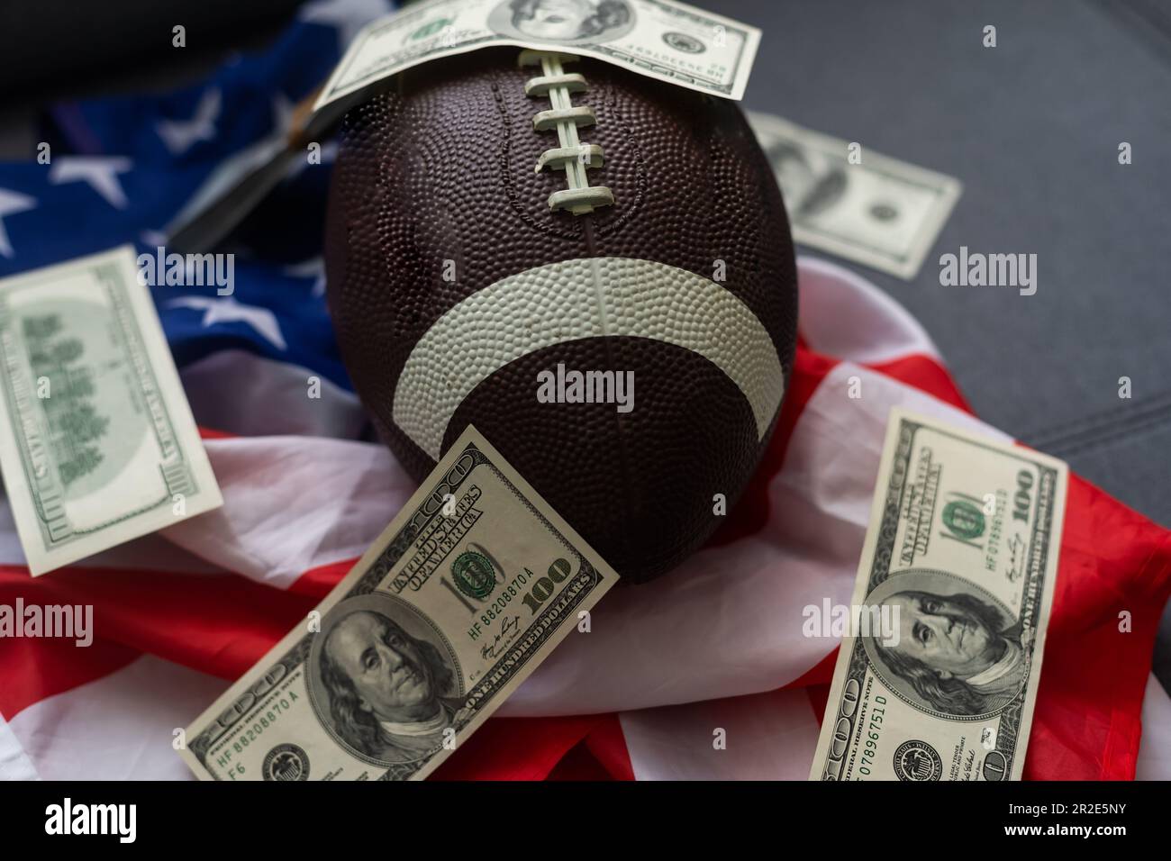 American football rugby ball and dollars on usa flag. Sports game Stock ...