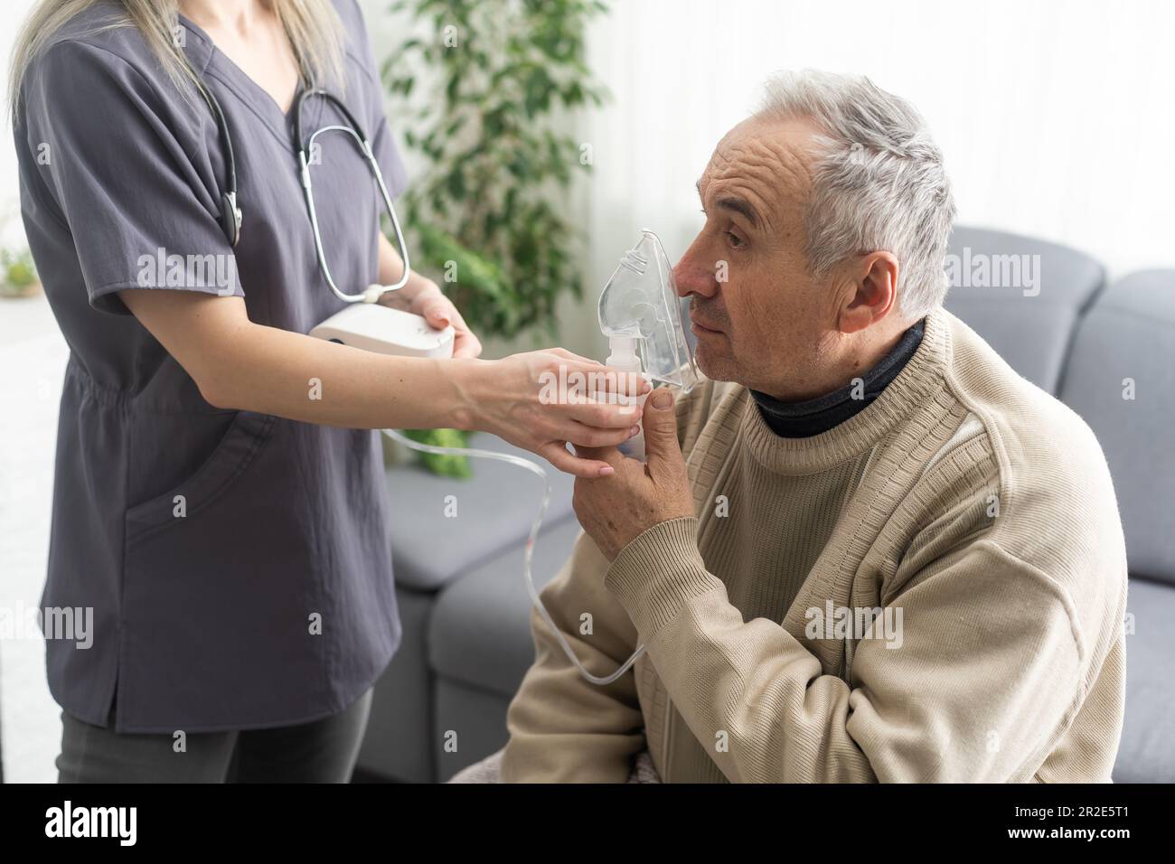 Elderly Senior Man nursing care wear oxygen inhaler device for helping ...