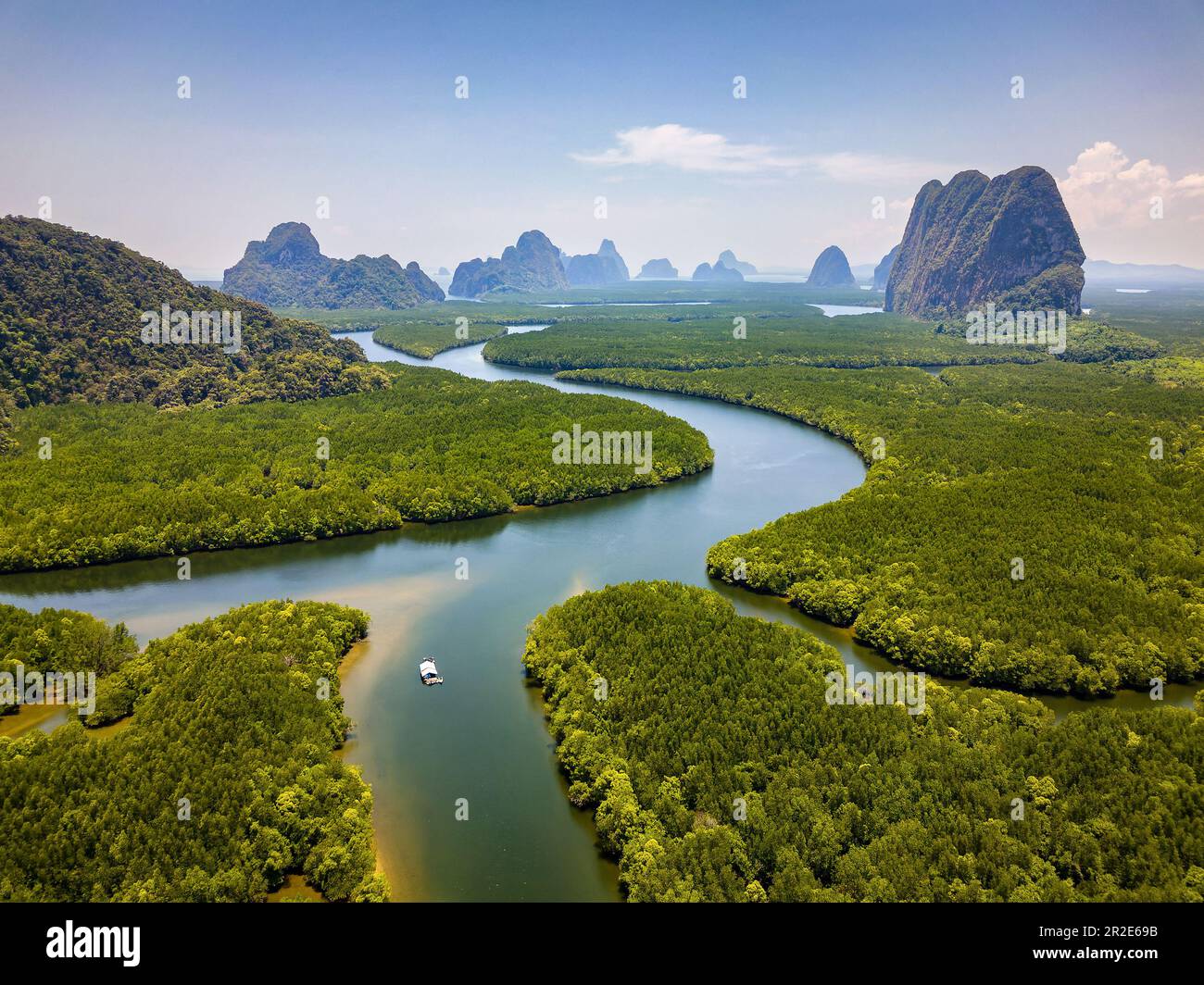 Aerial view of a huge mangrove forest and towering limestone pinnacles ...