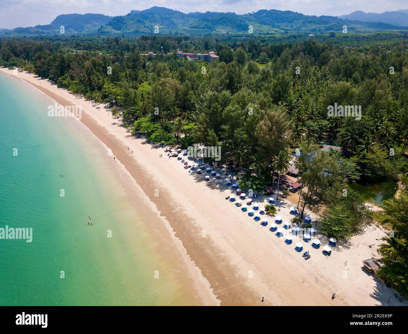 Aerial view of a small beach bar on a tropical sandy beachd fringed by ...