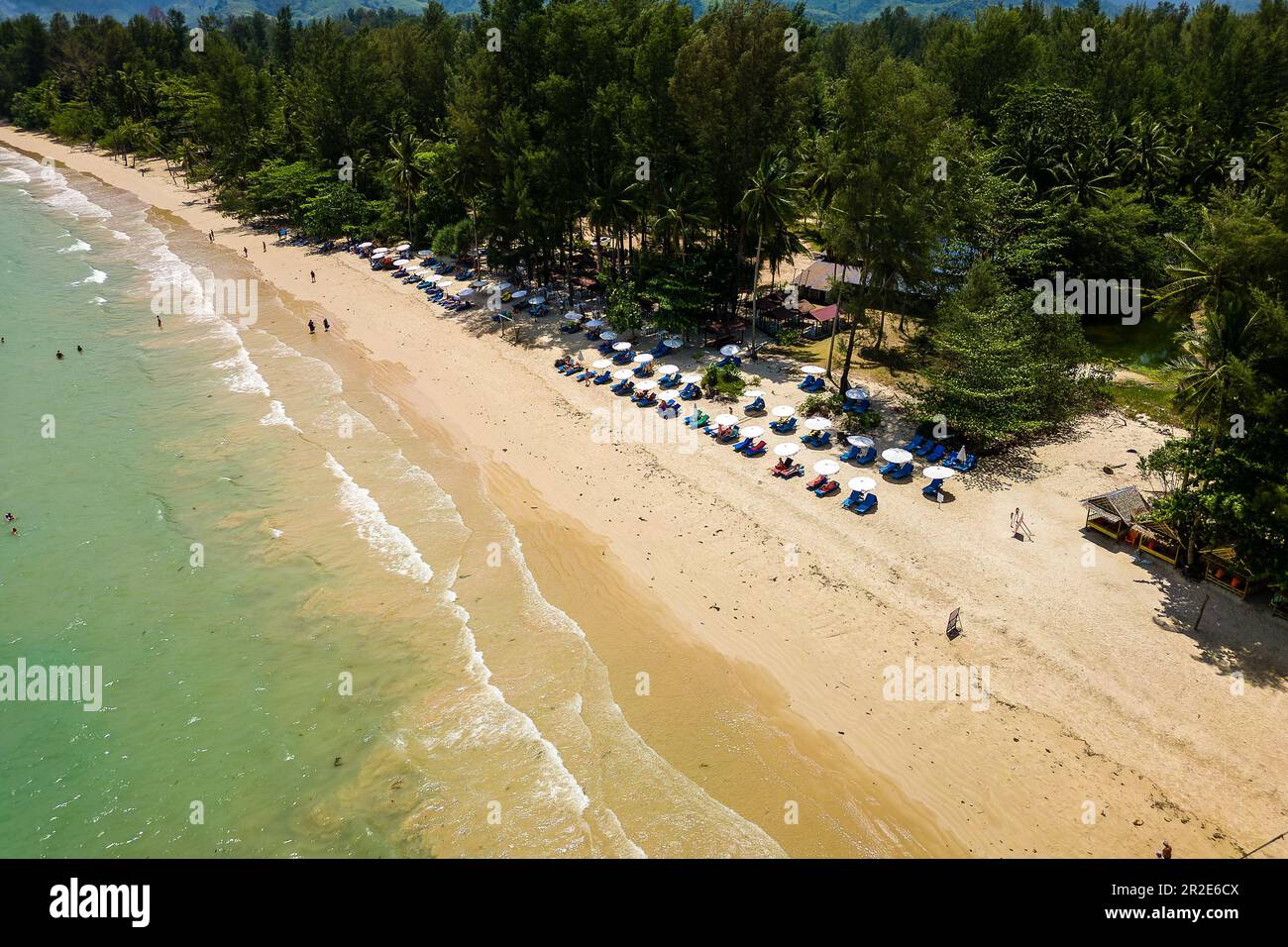 Aerial view of a small beach bar on a tropical sandy beachd fringed by ...