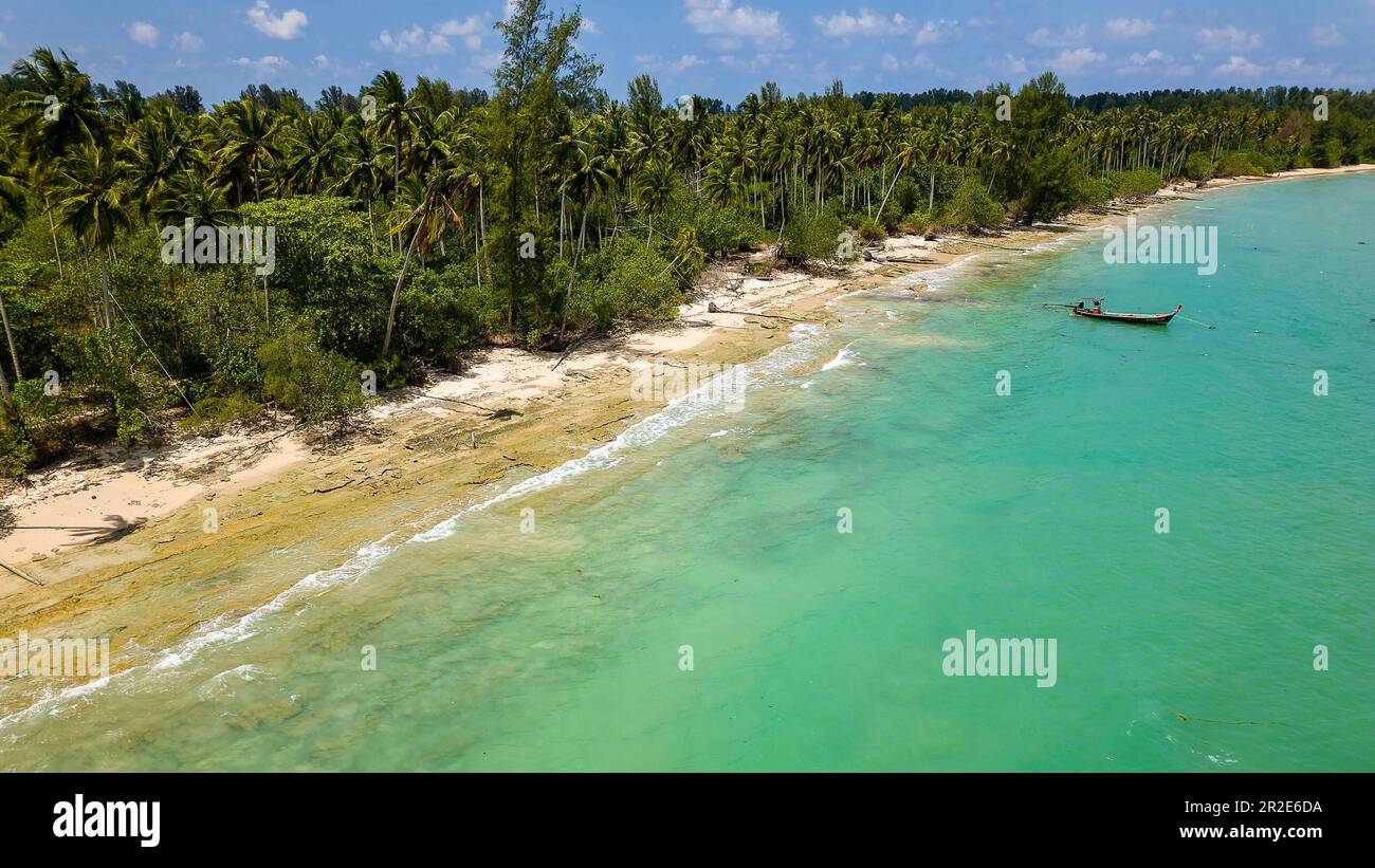 Low aerial view of a tropical beach surrounded by palm trees Stock ...