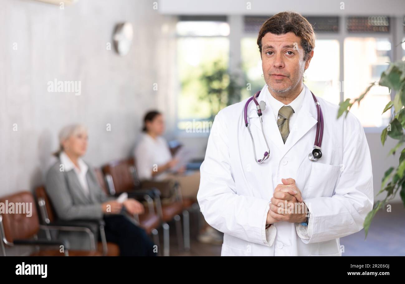 Adult male doctor posing in clinic reception Stock Photo - Alamy