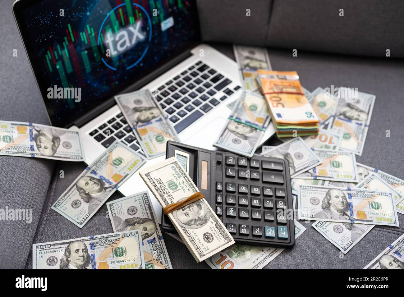 Dollar bills on a background laptop with charts Stock Photo - Alamy