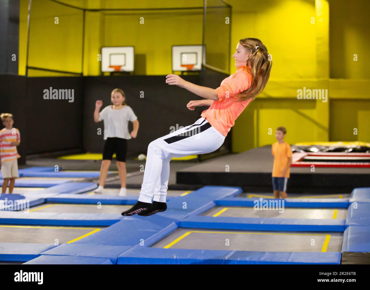 Teen girl jumping on trampoline on indoor inflatable playground Stock ...