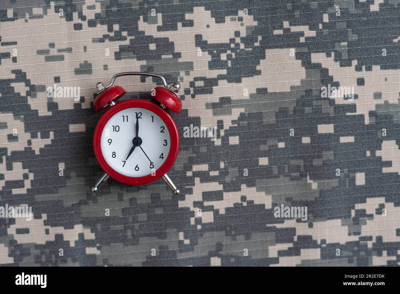 military uniform background and alarm clock Stock Photo - Alamy