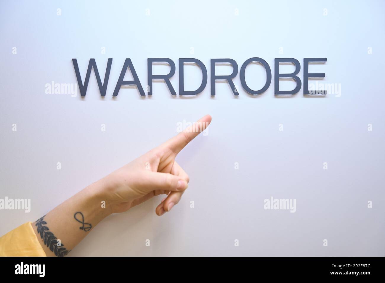 Close up of woman hand showing at wardrobe sign Stock Photo - Alamy