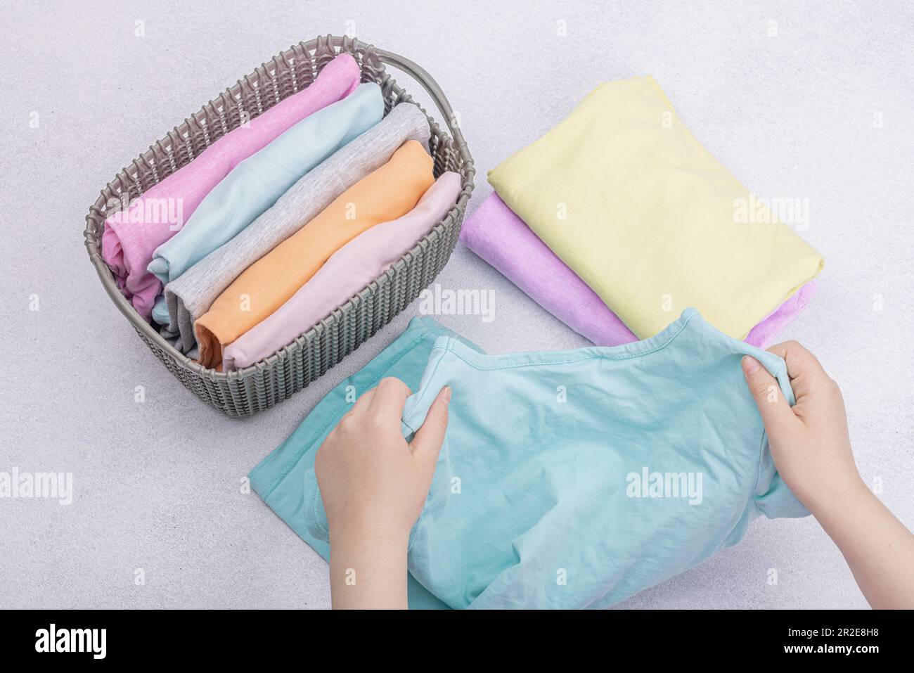 Children's hands fold clean clothes. Vertical storage of clothing in ...